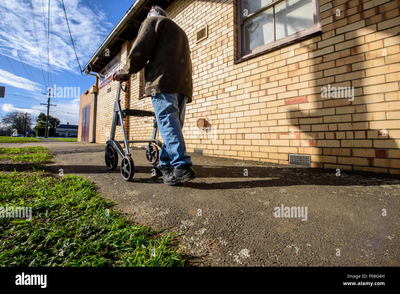 Elderly man with walking frame on sunny day Stock Photo - Alamy