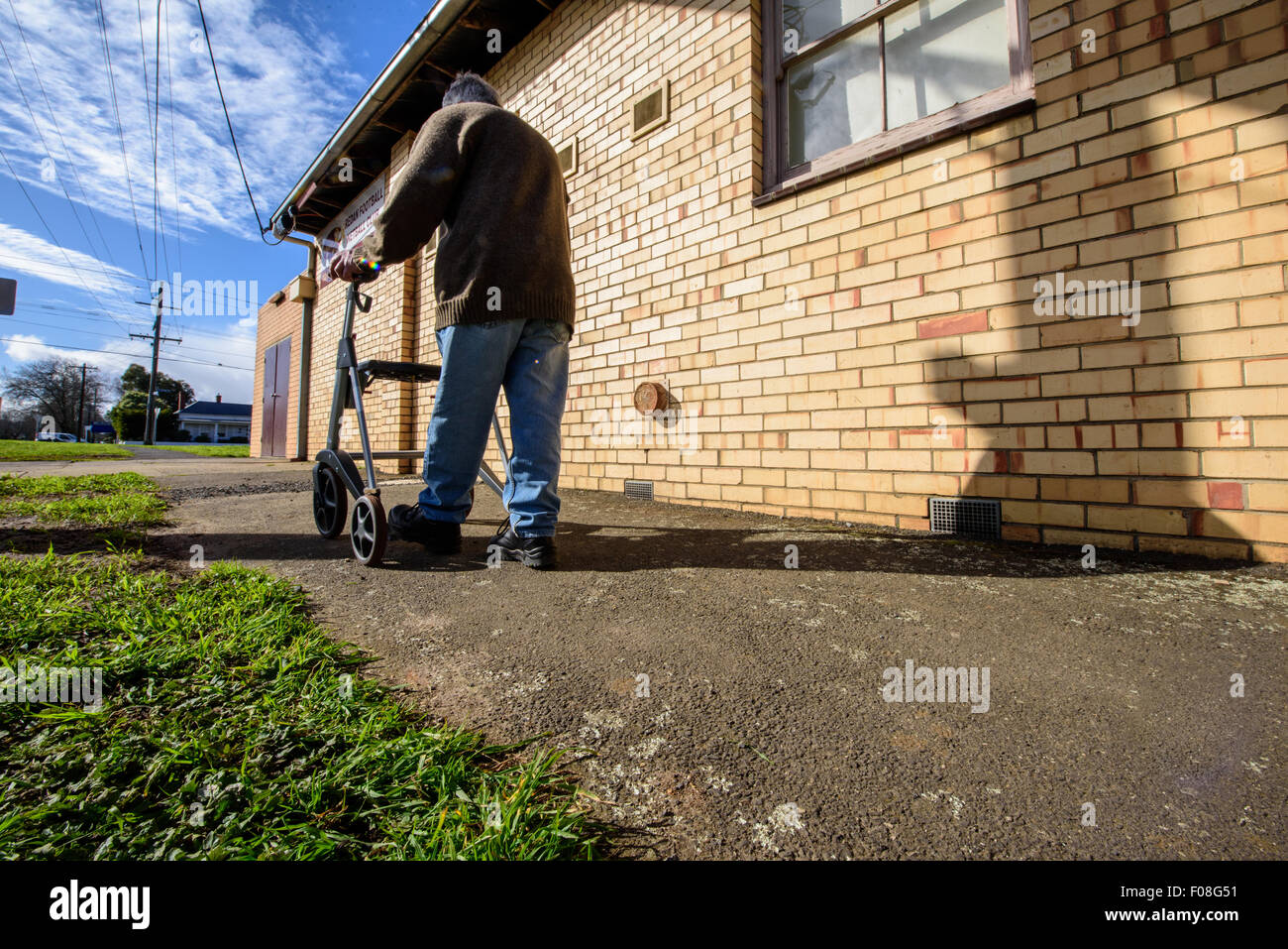 Elderly man with walking frame on sunny day Stock Photo - Alamy