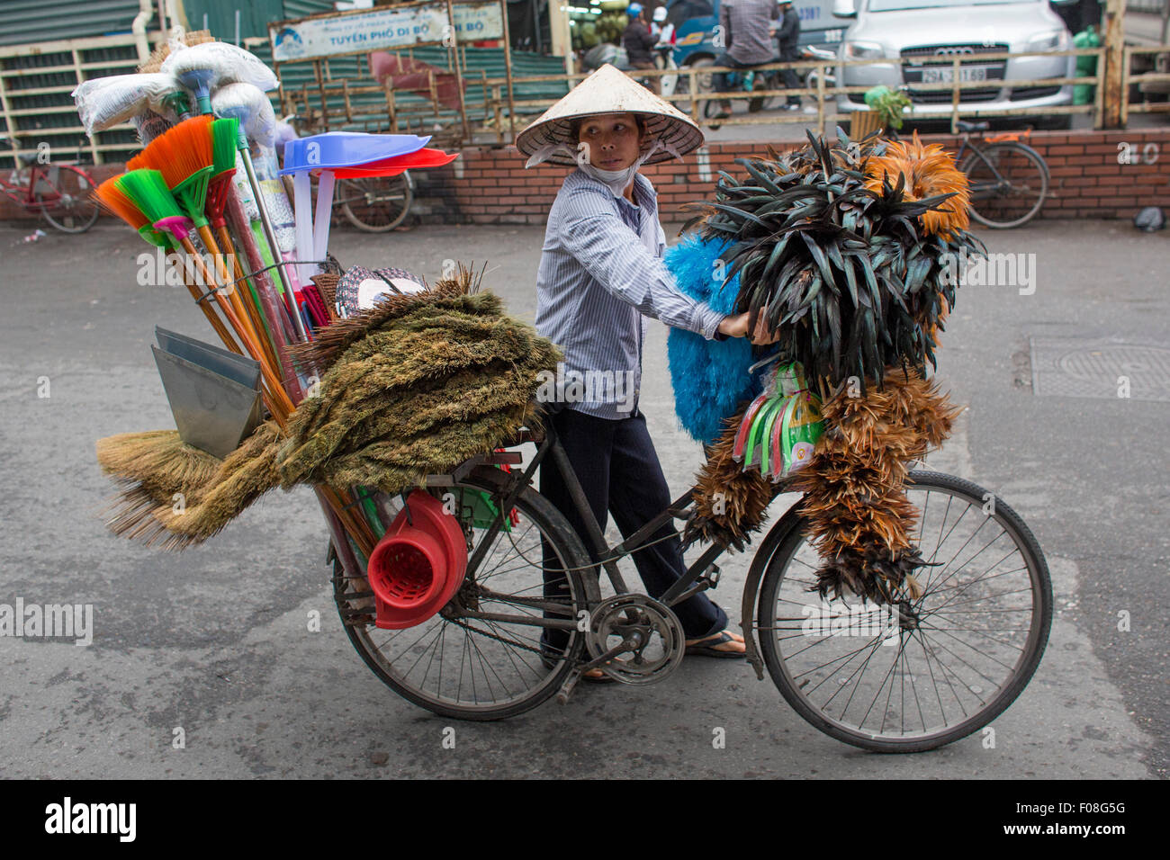 vendor selling household goods from her mobile bicycle shop Stock Photo ...