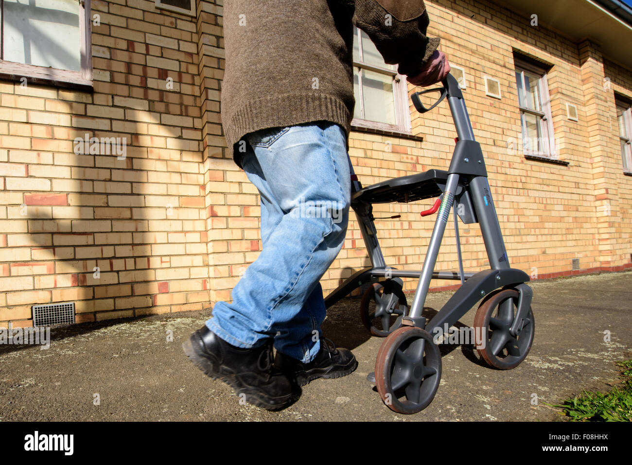 Elderly man with walking frame on sunny day Stock Photo - Alamy