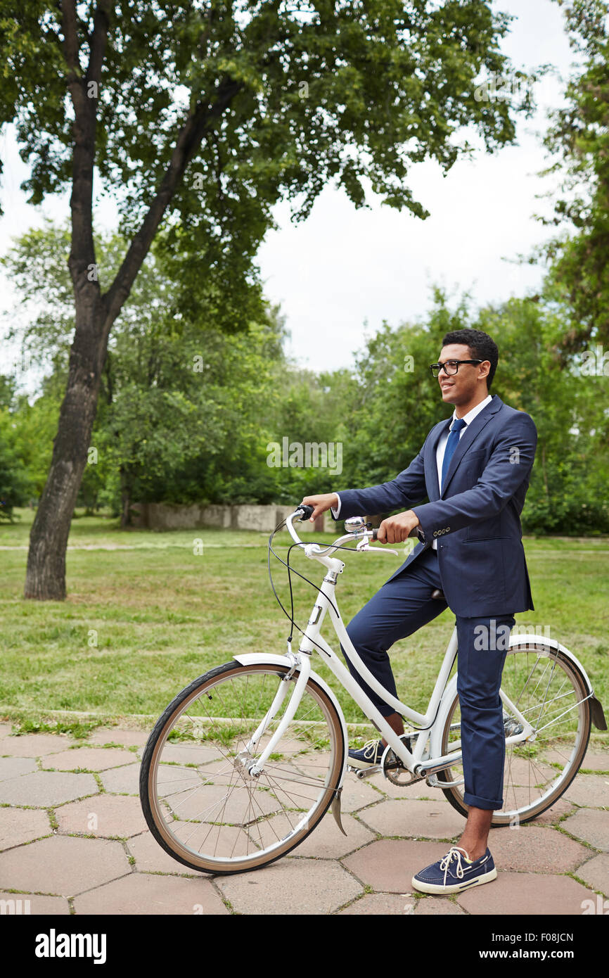 Businessman riding bicycle in park hi-res stock photography and images ...