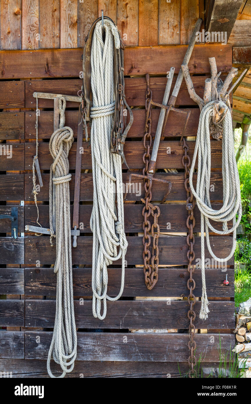 Ropes, chains and other farming implements hanging outside a timber ...