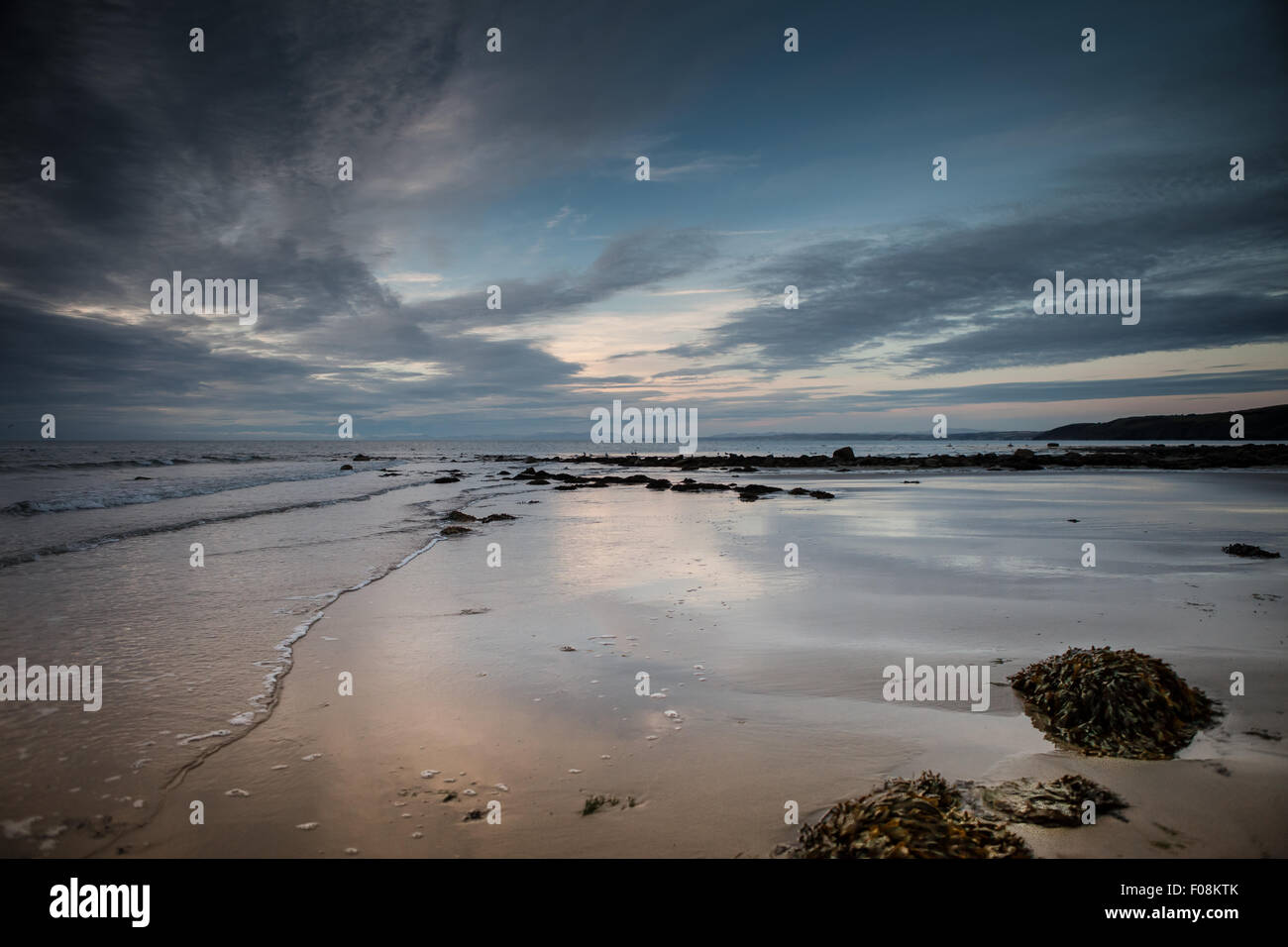 Quiet calm of the ocean retreating from the beach front Stock Photo - Alamy