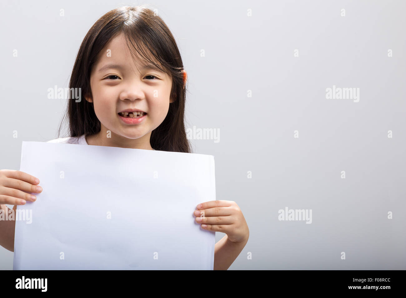Studio isolated kid holding white sheet of blank paper Stock Photo - Alamy