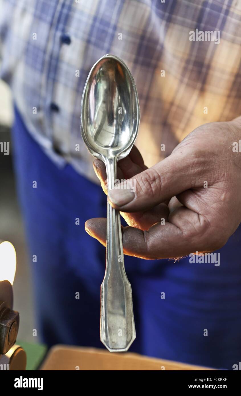 Hand holding silver spoon hi-res stock photography and images - Alamy