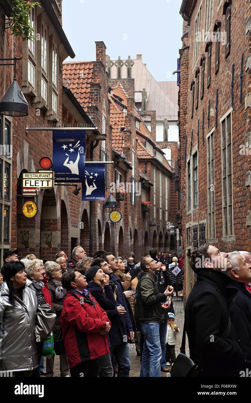 Tourist looking upward to Bottcherstrasse building, Bremen, Germany ...