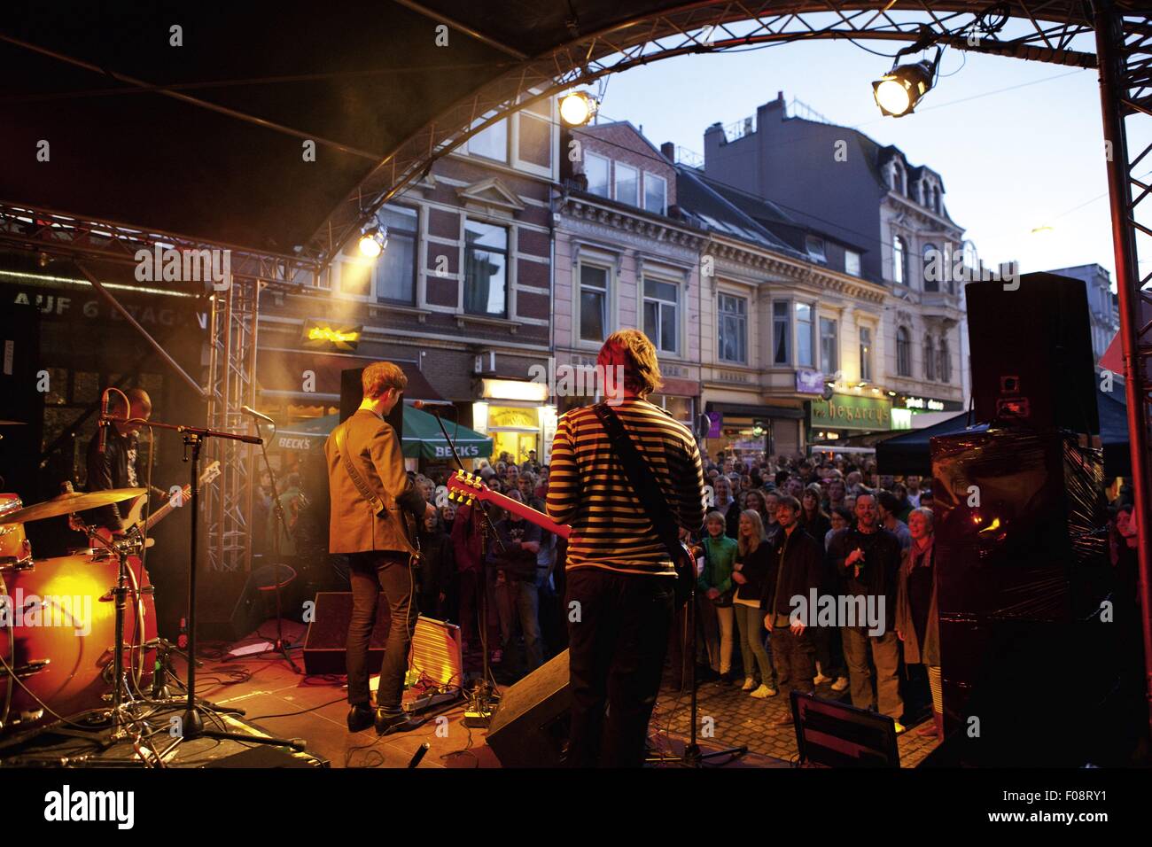 People performing on stage with guitar in Easter Steinweg buskers ...