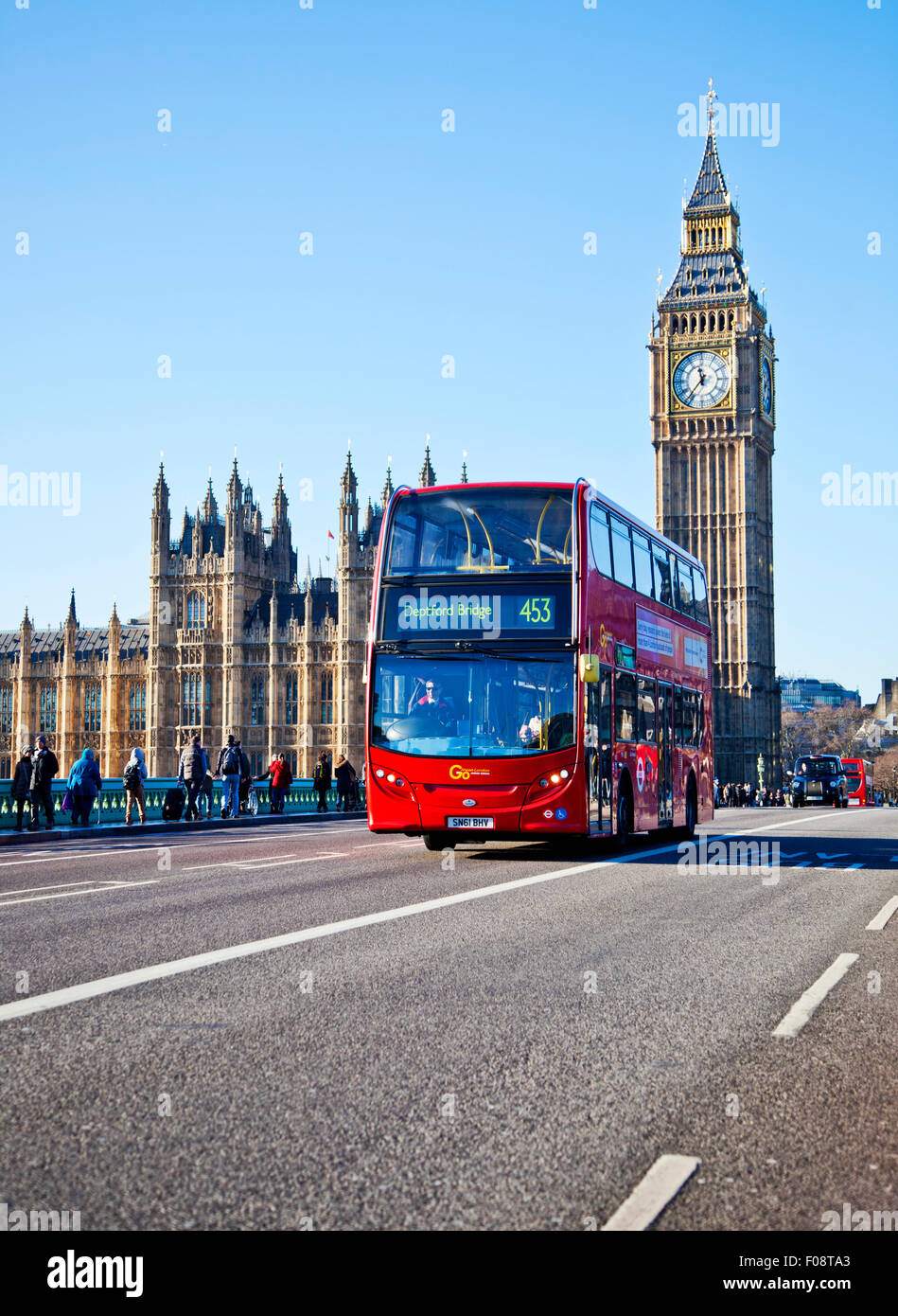 LONDON - DEC 29: Iconic London bus crossing Westminster Bridge in the ...