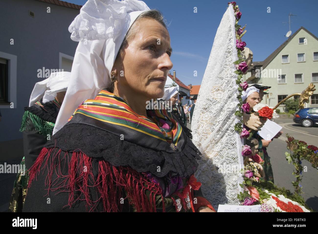 Woman in traditional wear performing rituals in Franconian Switzerland ...
