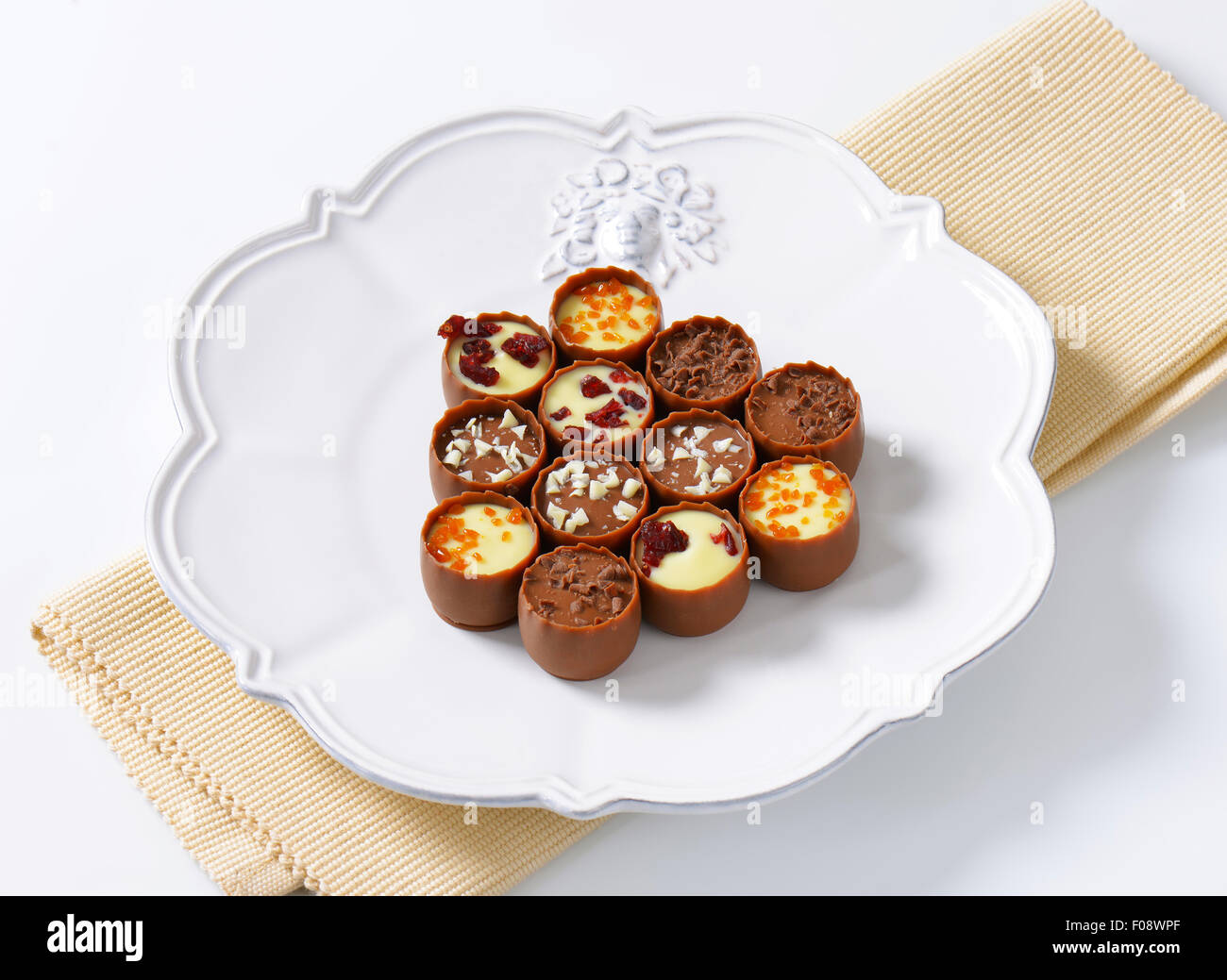 Delicate milk chocolate cups with liqueur and ganache centres Stock ...