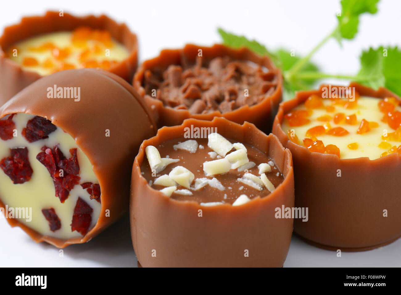 Delicate milk chocolate cups with liqueur and ganache centres Stock ...
