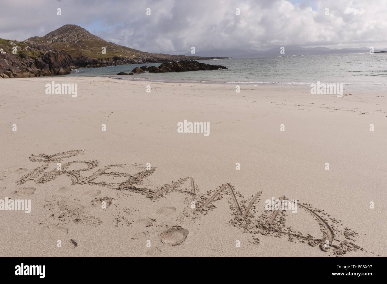 Close-up of Ireland written on sand at Ring of Kerry Inch Beach ...