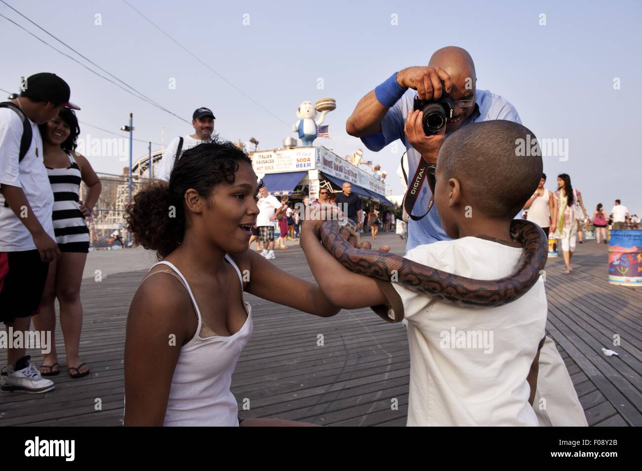 Man and woman with snakes around their neck at Coney Island, New York ...