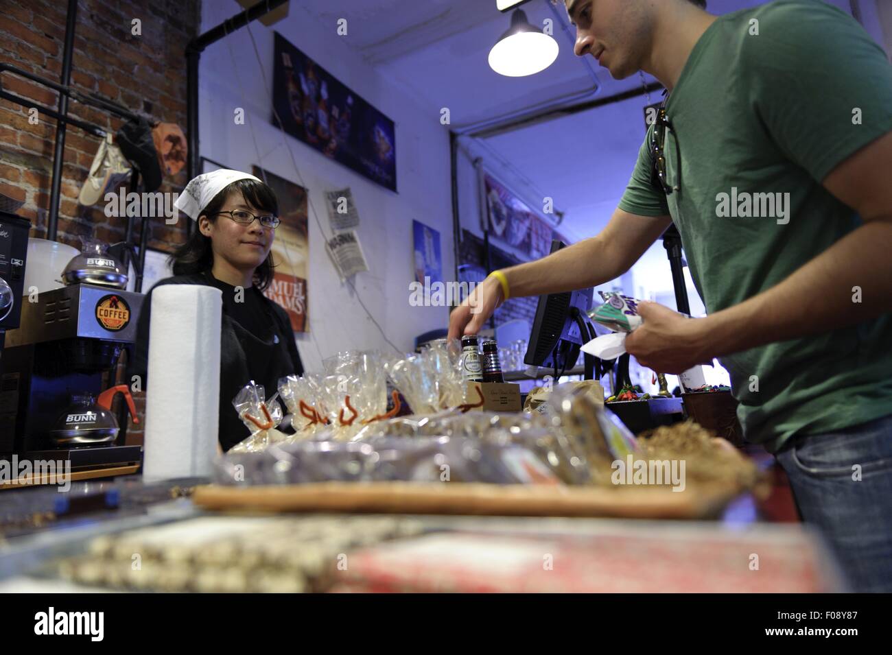 Man standing at counter in store at Fifth Avenue, Manhattan, New York ...