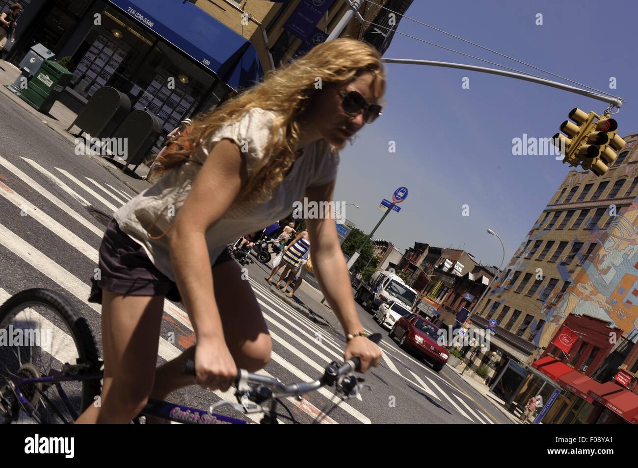 Woman on bicycle over crossing in New York, USA Stock Photo - Alamy