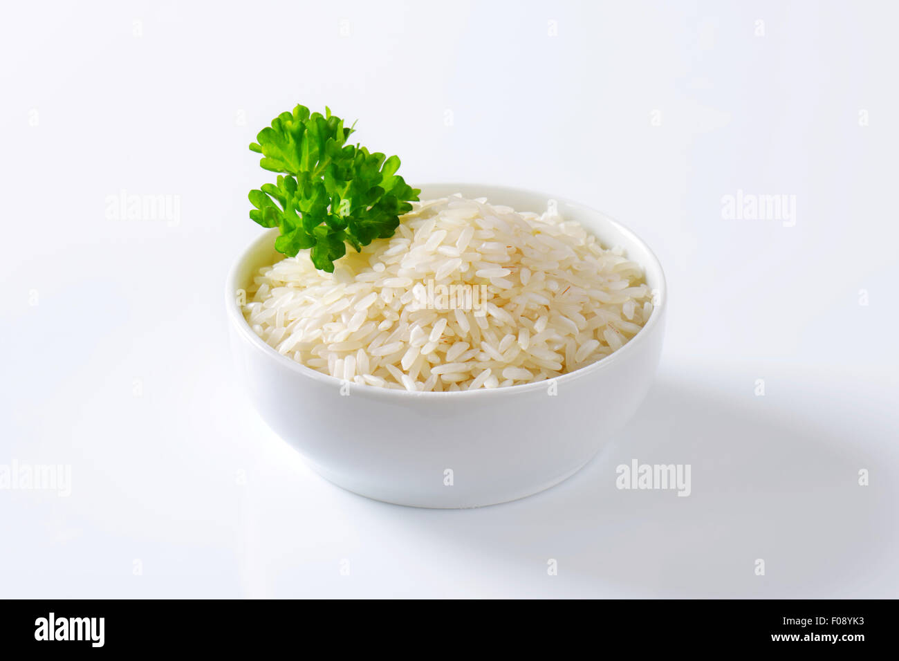 Bowl of uncooked white rice Stock Photo - Alamy