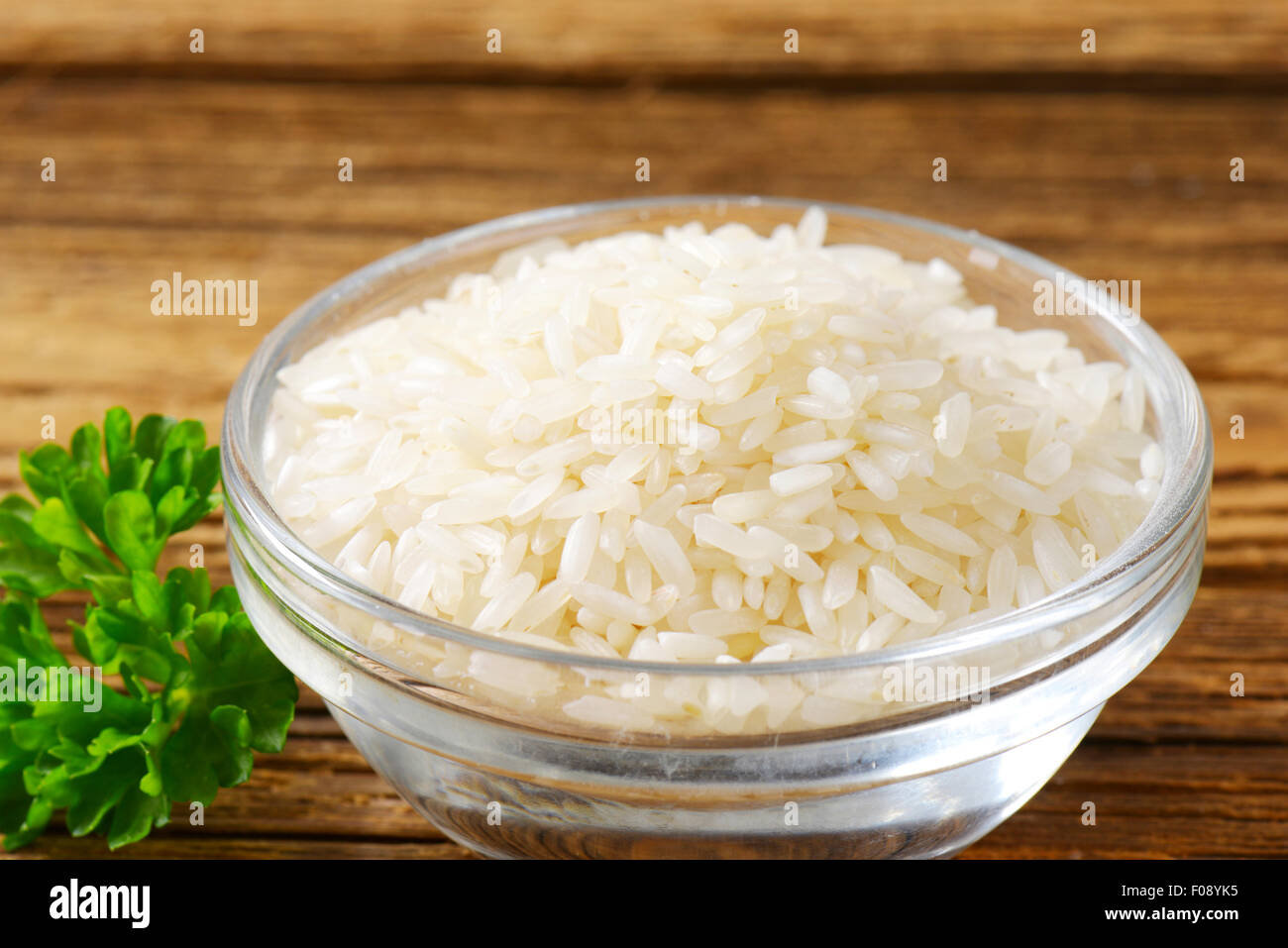 Bowl of uncooked white rice Stock Photo - Alamy