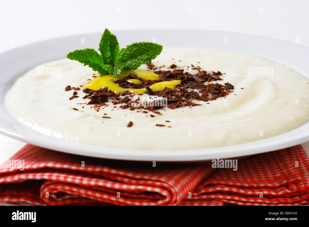 Smooth semolina porridge served with grated chocolate and lemon curd ...