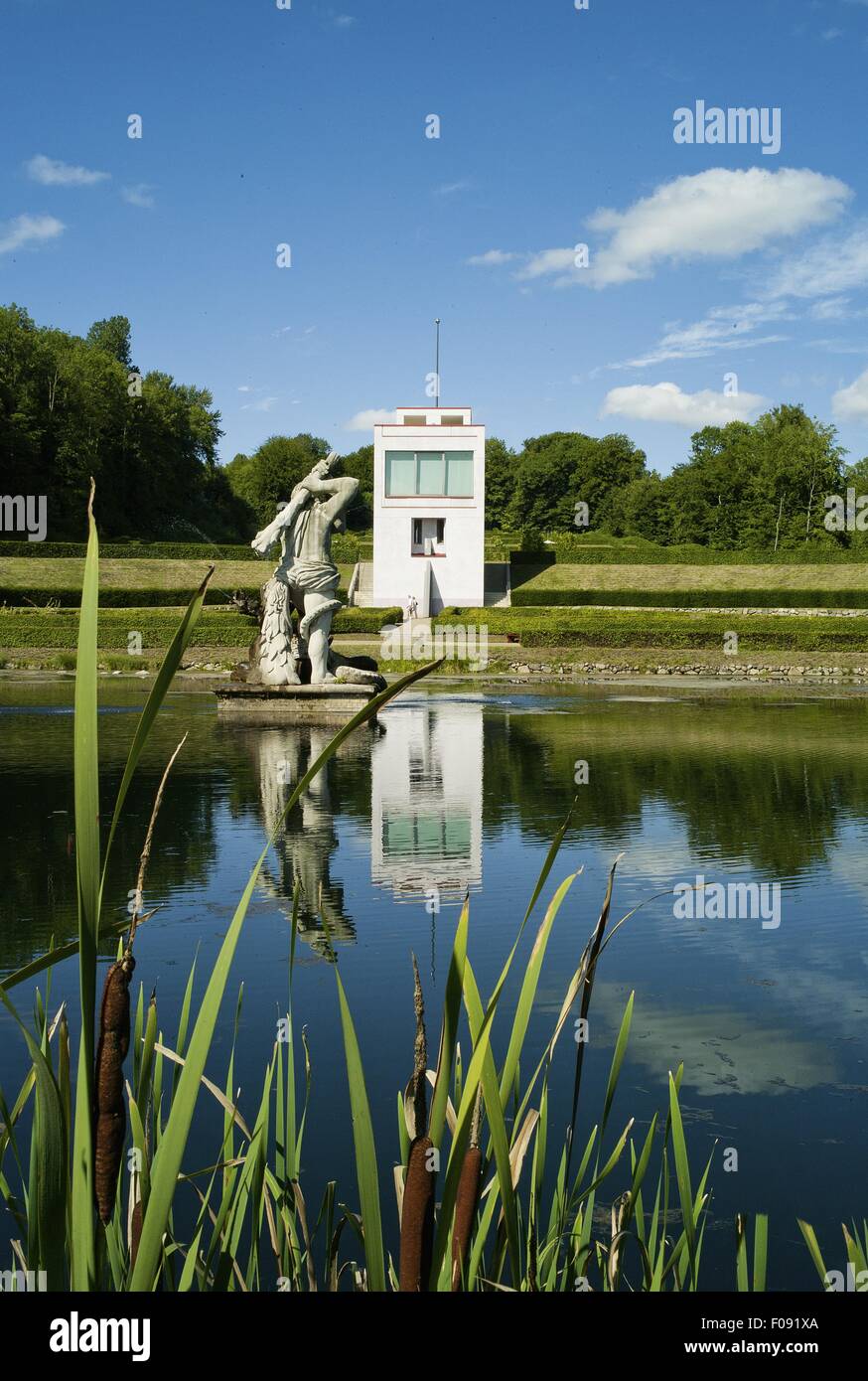 View of Schleswig Gottorp Castle Park with statue reflection in water ...