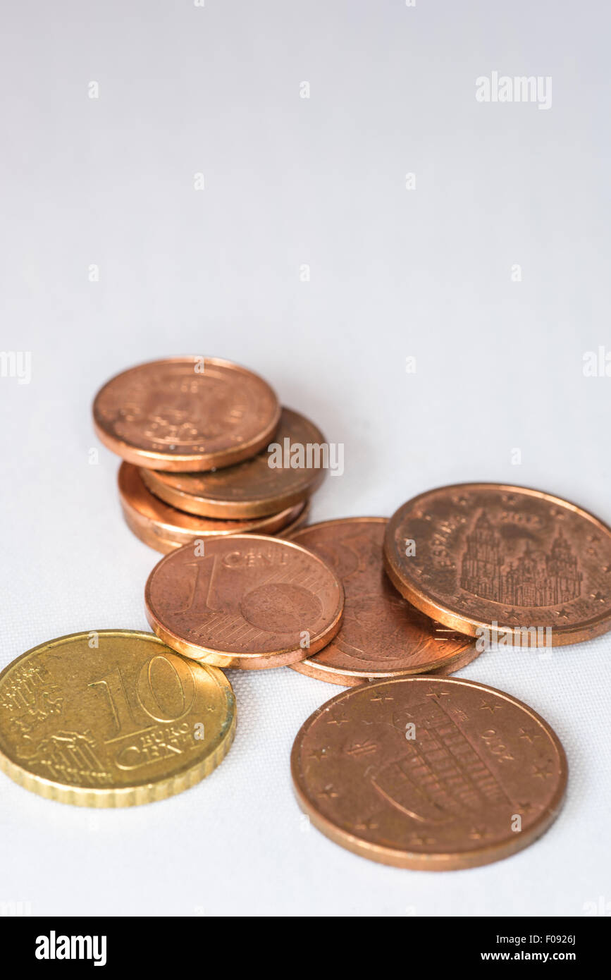 A small pile of Euro small denomination coins on a white background ...