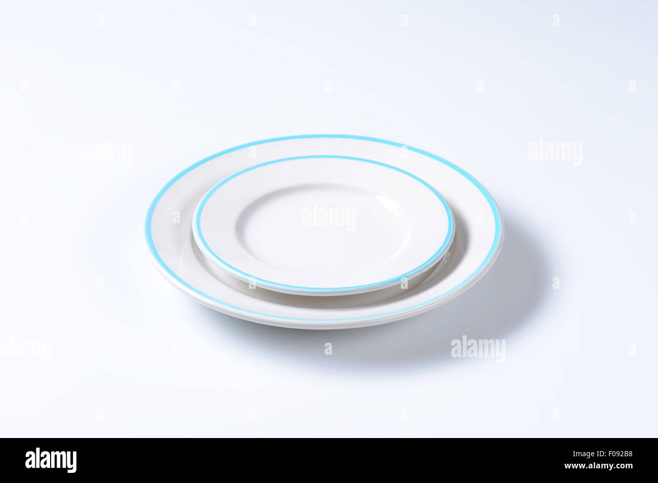 Dinner plate and side plate with blue colored edges Stock Photo - Alamy