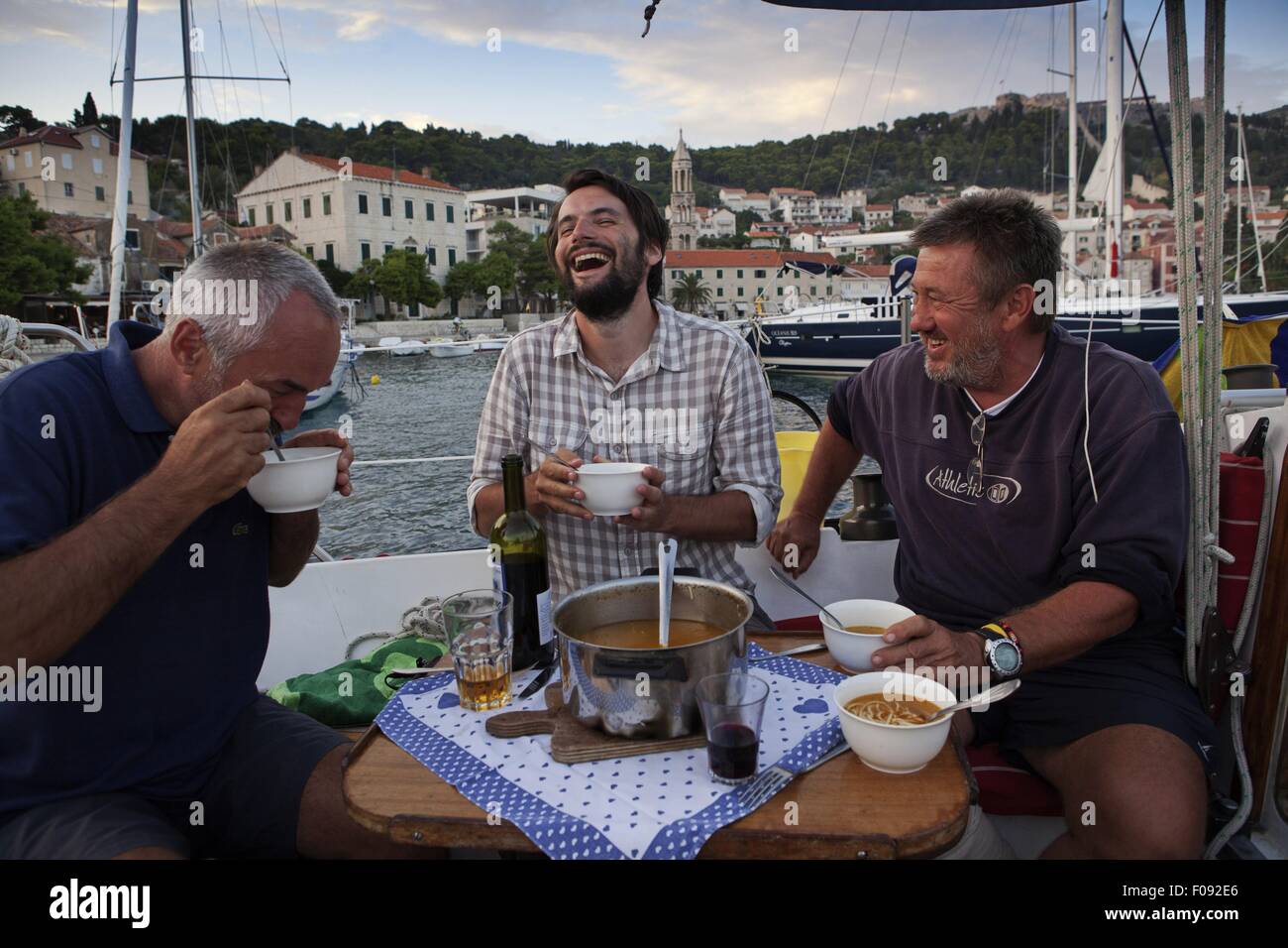 Three sailing crew having fun at harbour, Croatia Stock Photo - Alamy