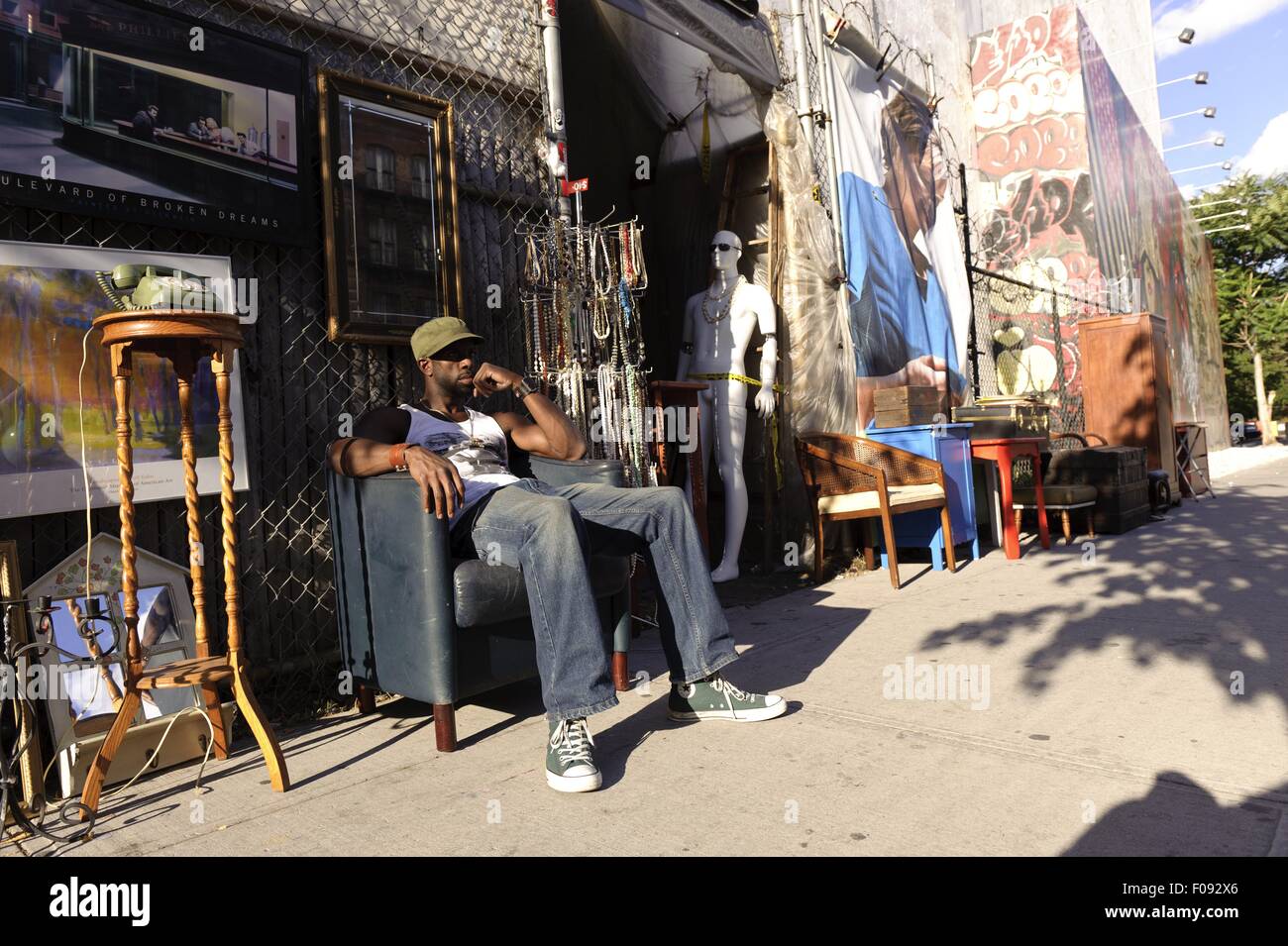 Timothy dark street rapper sitting on chair on street, New York Stock ...