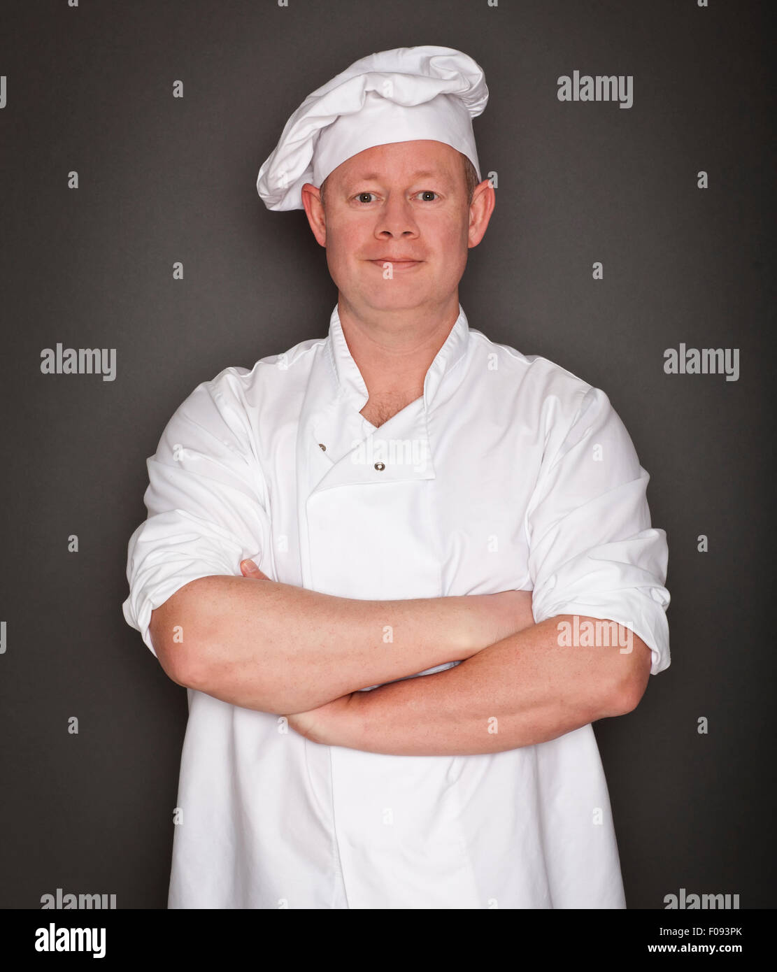 Male chef standing with folded arms studio portrait Stock Photo - Alamy