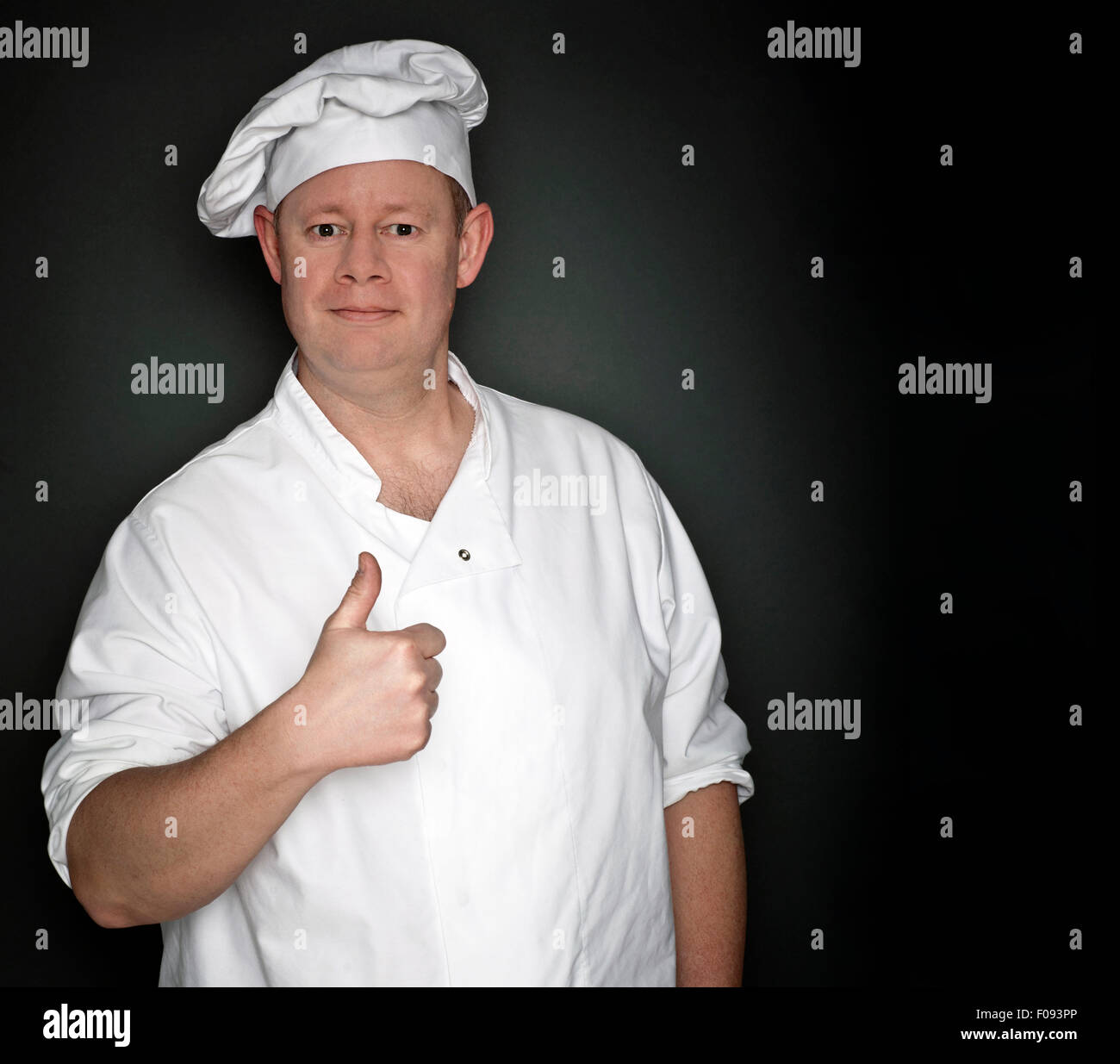 Male chef giving a positive thumbs up hand sign Stock Photo - Alamy