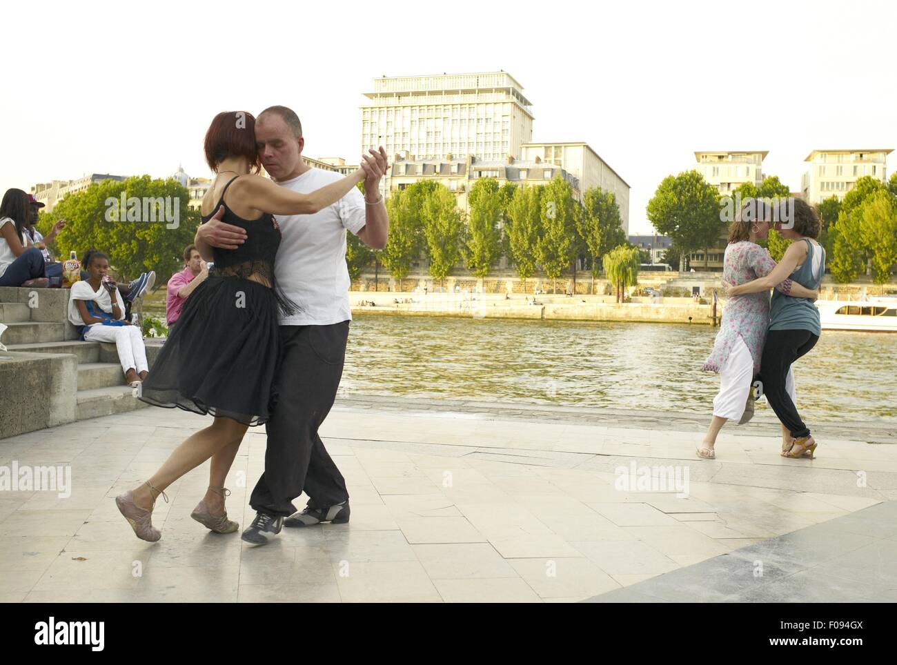 Couple dancing at the bank of Seine River in Paris, France Stock Photo ...