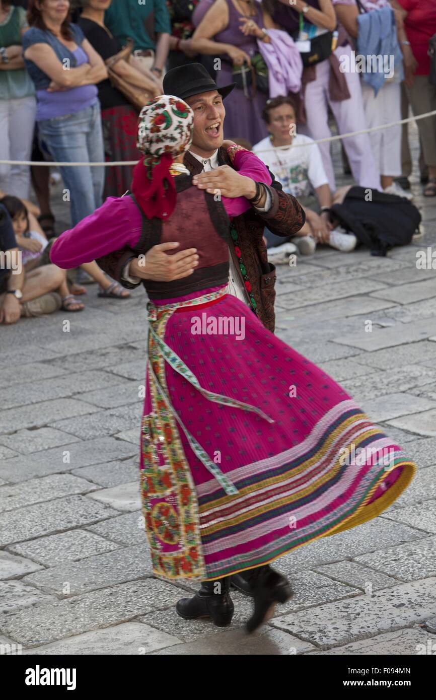 Couple performing traditional dance on pavement at Dubrovnik, Croatia ...