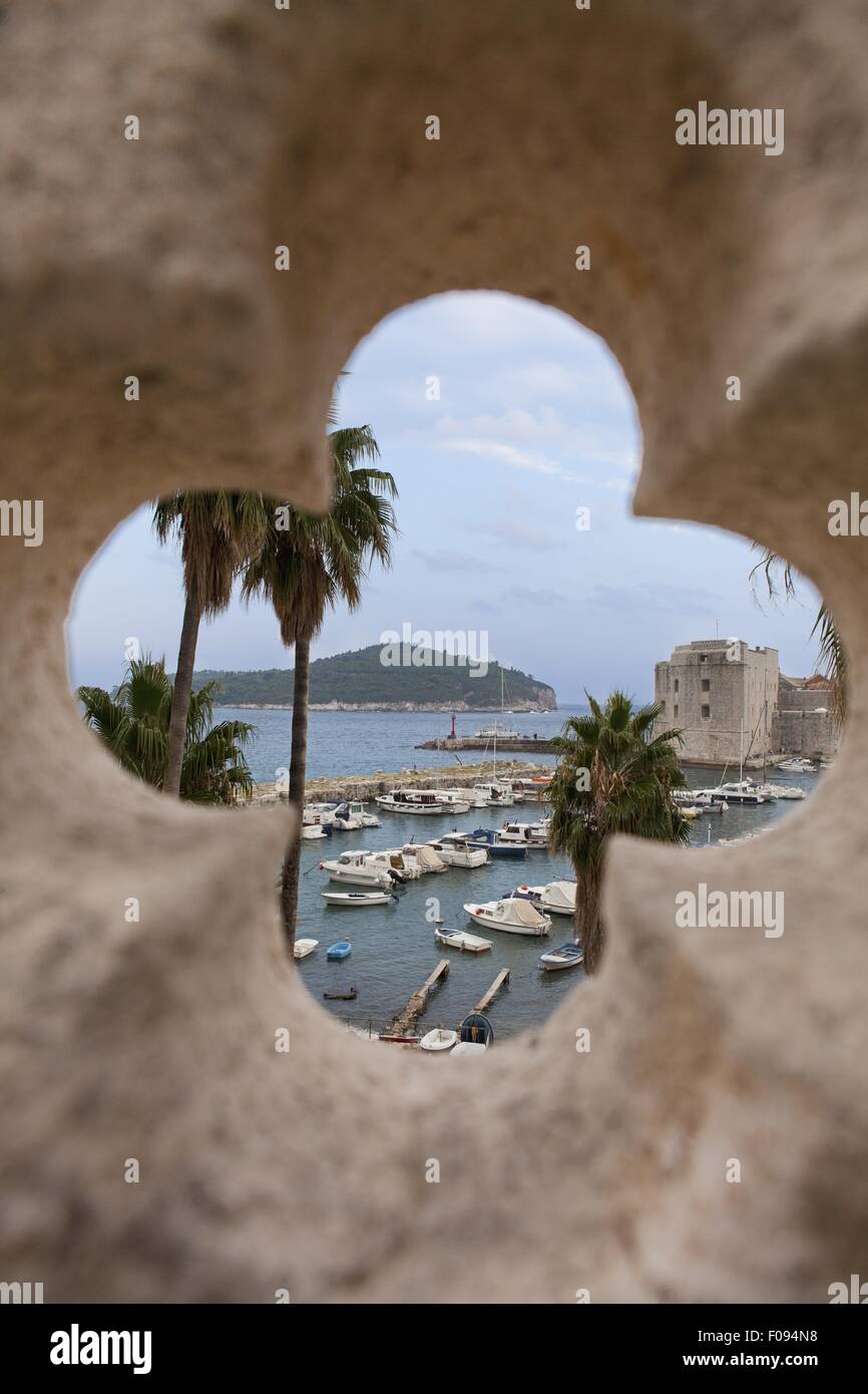 View of harbour and island through window embrasure of city wall in ...