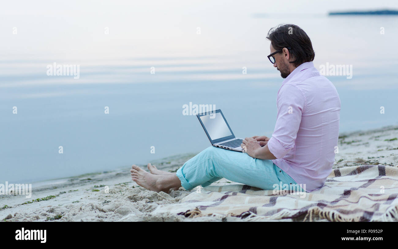 Writer with laptop Stock Photo - Alamy
