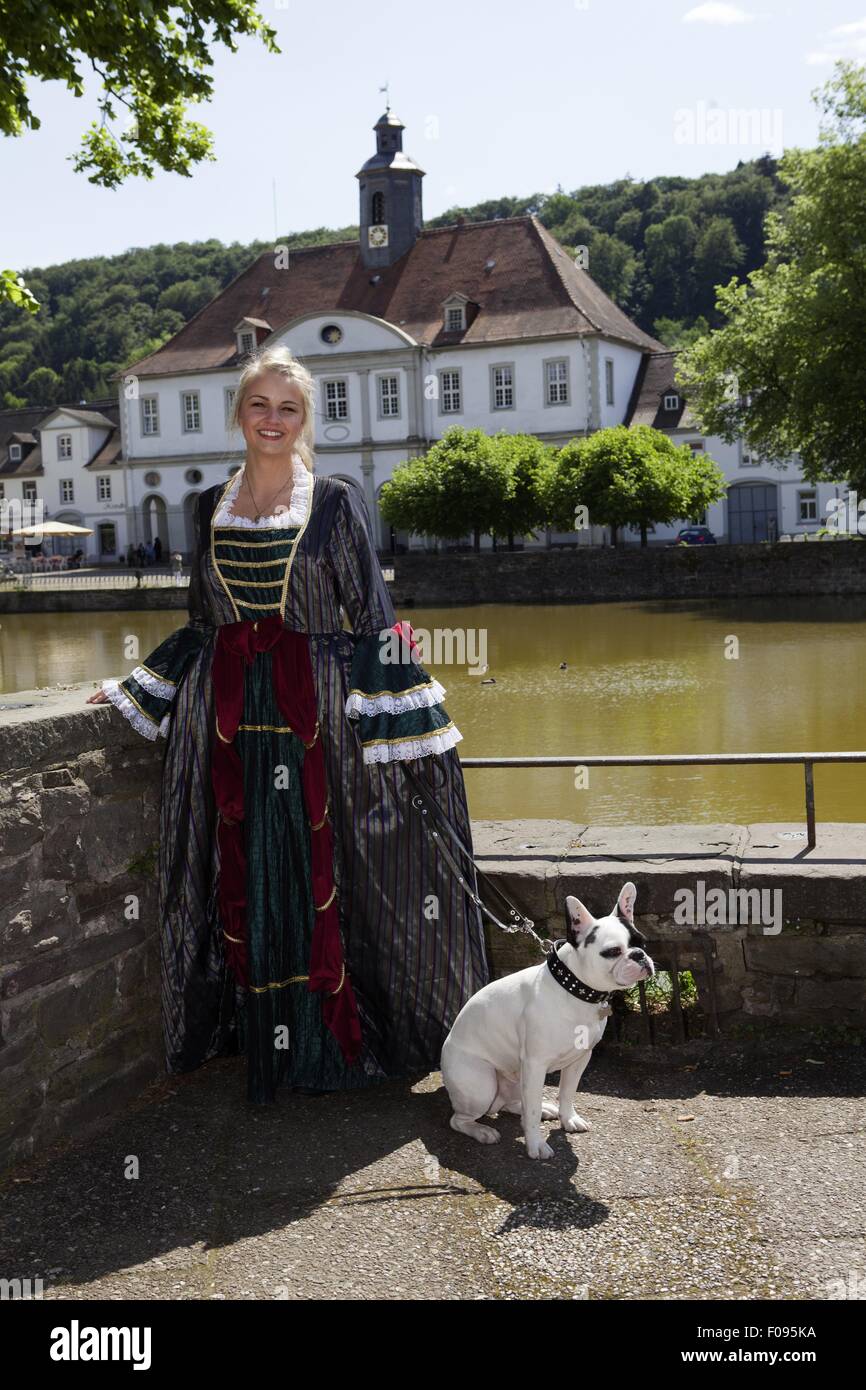 Woman dressed traditionally standing at Bad Karl harbour with dog ...