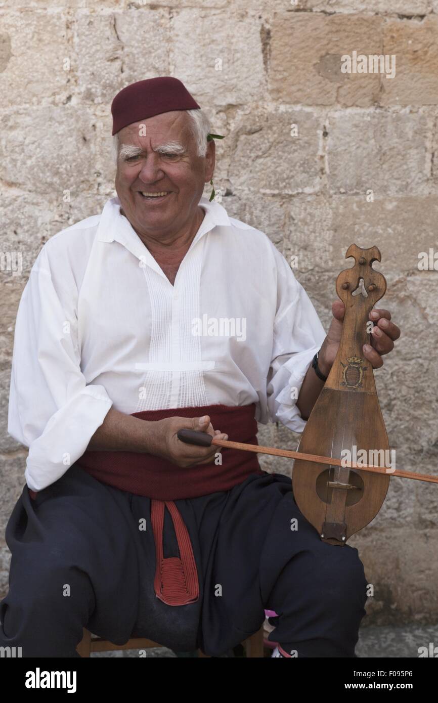 Street musician playing instrument at Dumbrovnik, Croatia Stock Photo ...