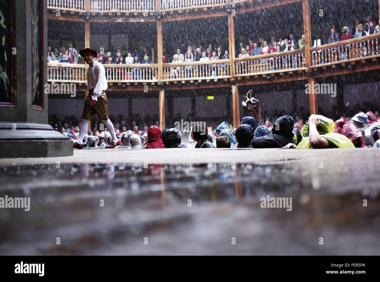 People in Auditorium of Globe Theatre during rain in London Borough of ...