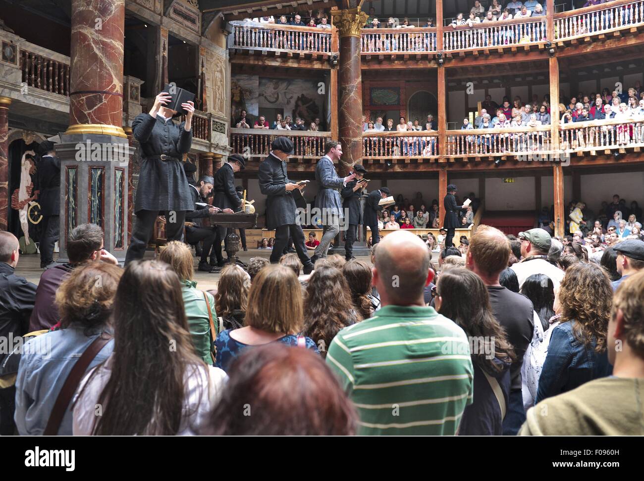 People watching performers on the stage at Globe Theatre, Southwark ...