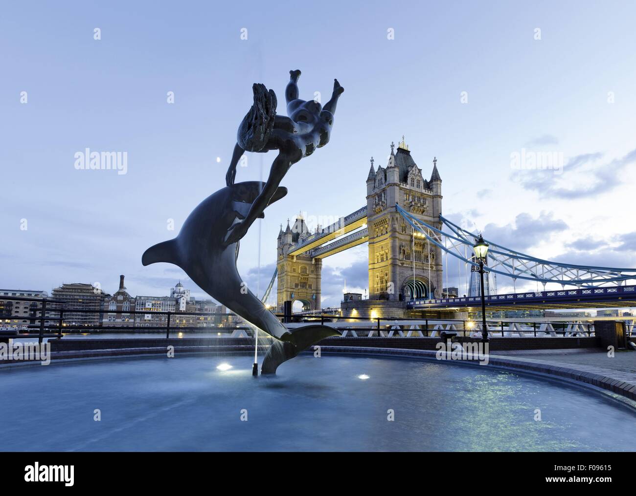 Sculpture of dolphin with girl and Tower Bridge in background at ...