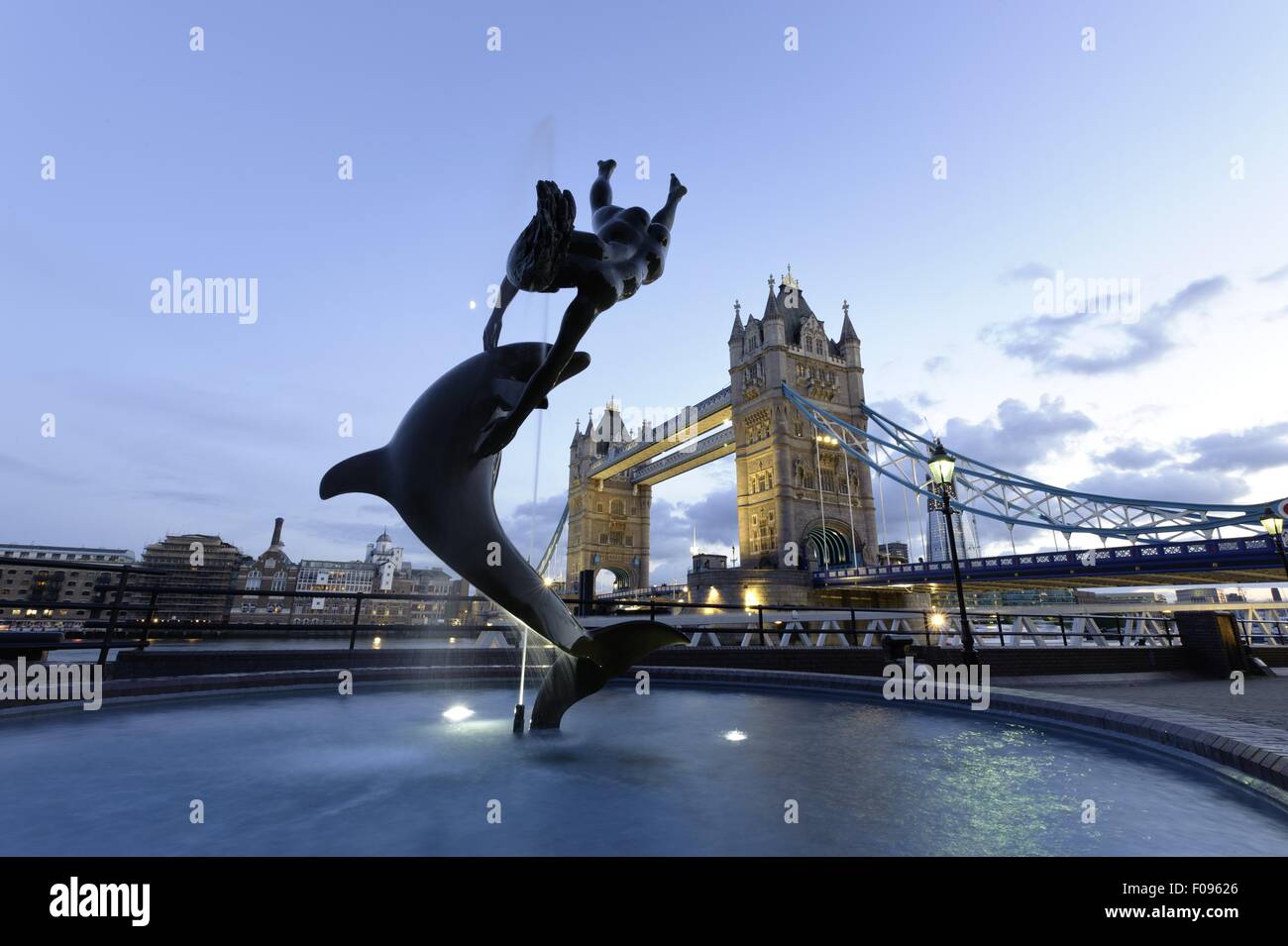 Sculpture of dolphin with girl and Tower Bridge in background at ...