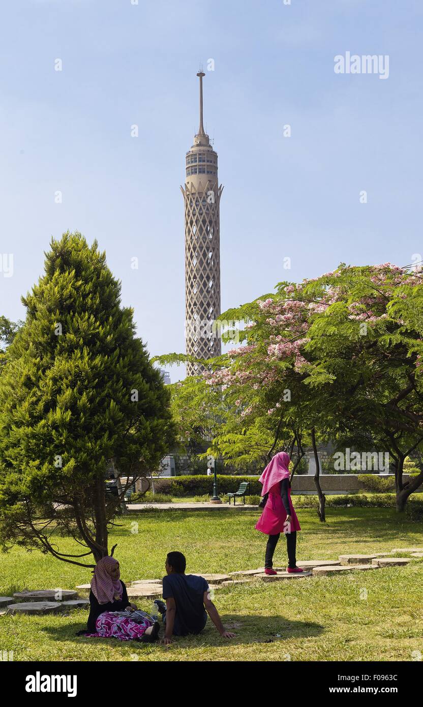 View of people relaxing in park and Cairo Tower in Zamalek, Gezira ...
