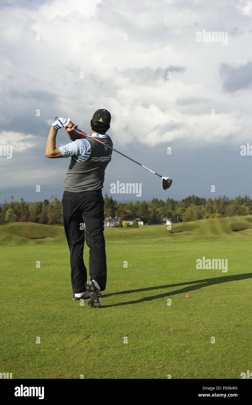 Rear view of golfer striking in golf course, Scotland Stock Photo - Alamy
