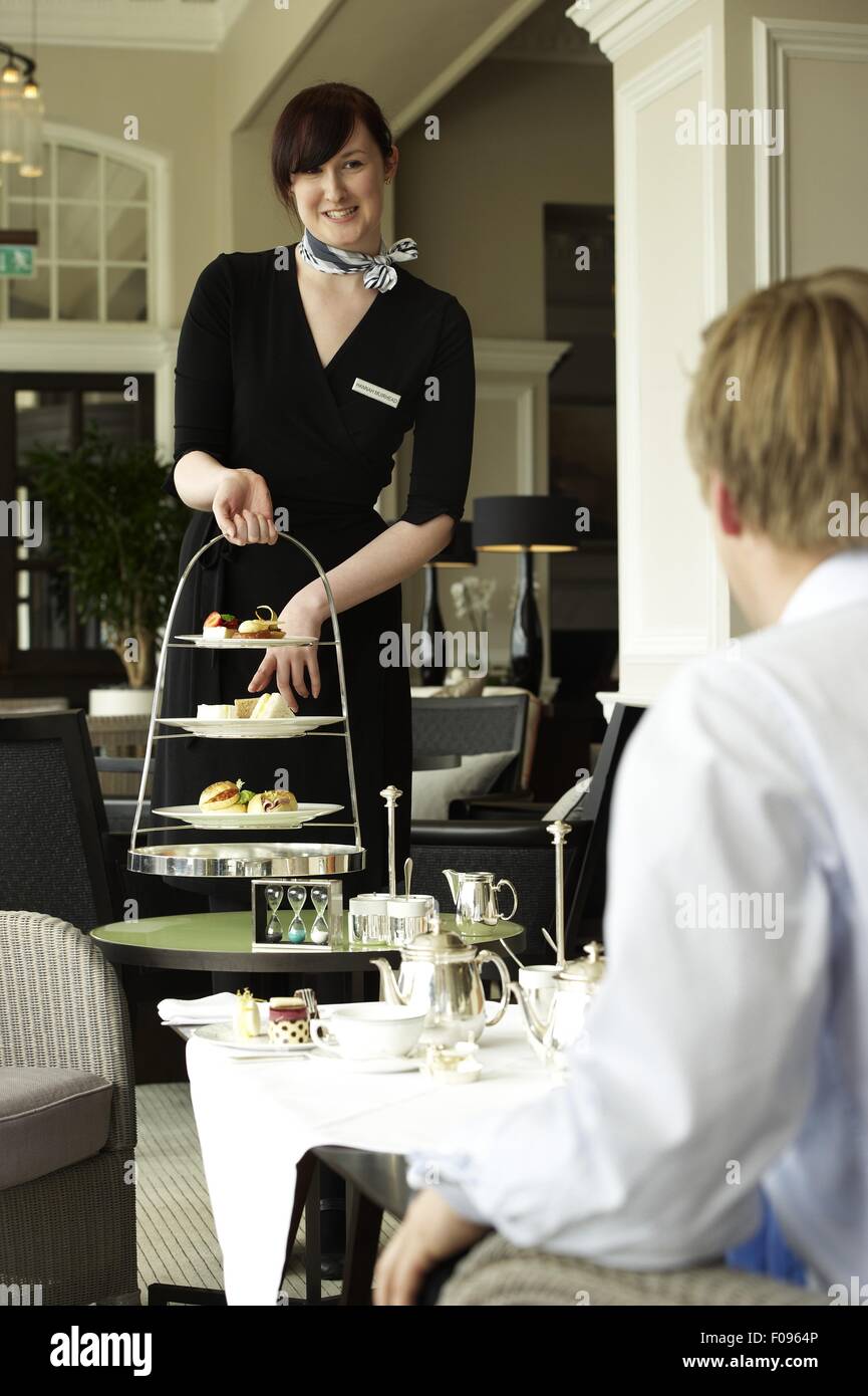 Waitress standing with tiered stand in Turnbery Resort, Scotland Stock ...