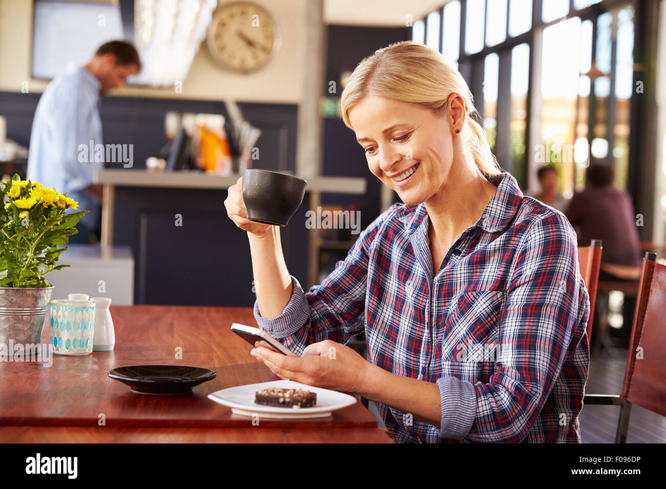 Woman using smart phone at a coffee shop Stock Photo - Alamy