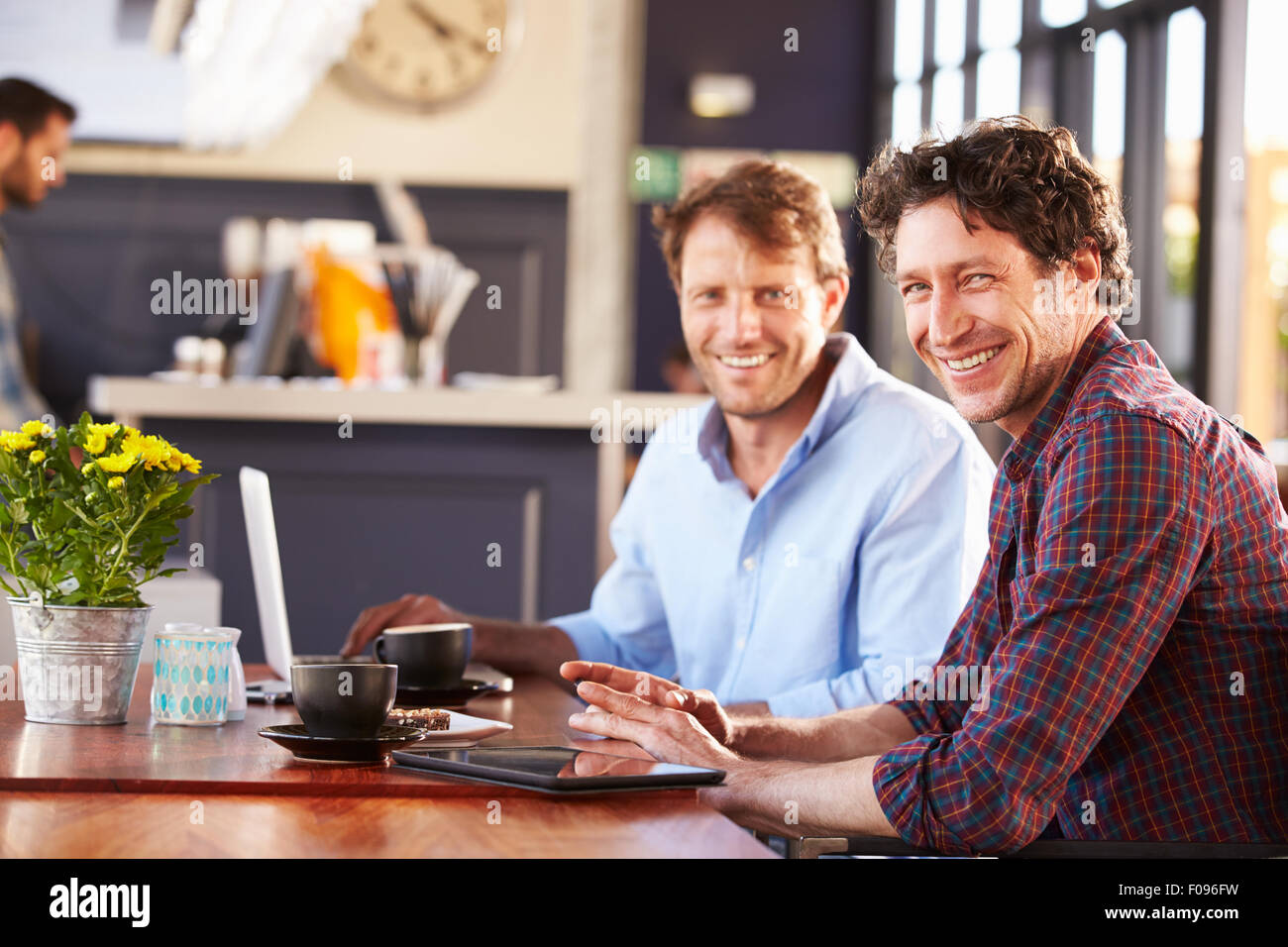 Two men meeting at a coffee shop, portrait Stock Photo - Alamy