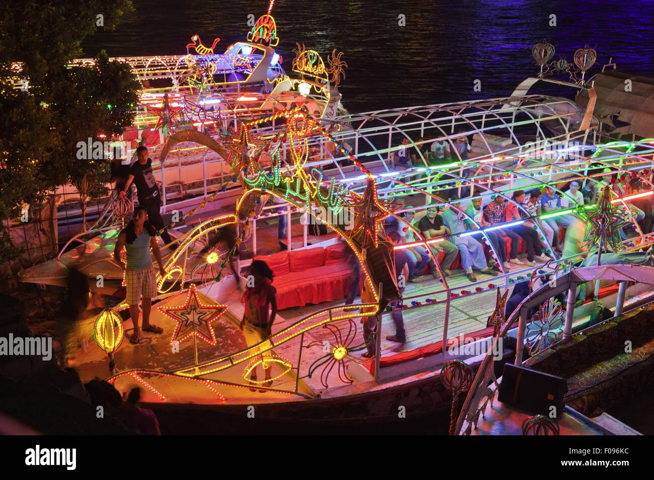 View of people in illuminated boat on Nile river, Cairo, Egypt Stock ...