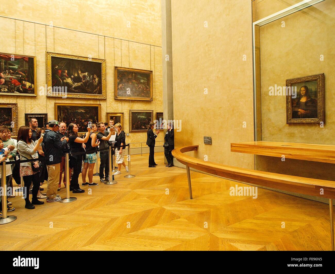 Tourists Photographing Mona Lisa In The Louvre Museum Paris France