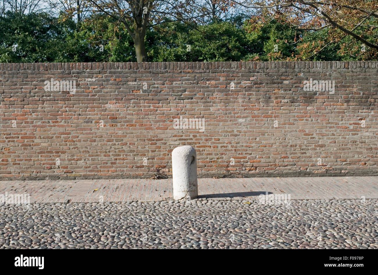 stone bollard and cobblestone road, Ferrara, Italy Stock Photo - Alamy