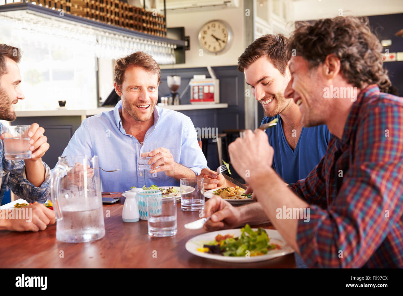 A group of friends having lunch in a restaurant Stock Photo - Alamy