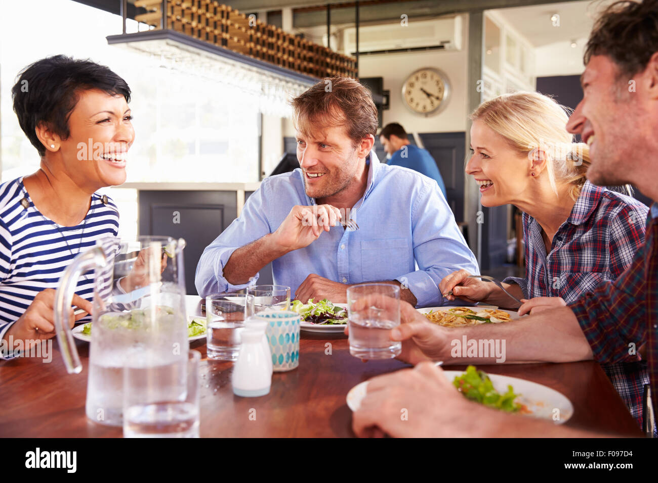 A group of friends having lunch in a restaurant Stock Photo - Alamy