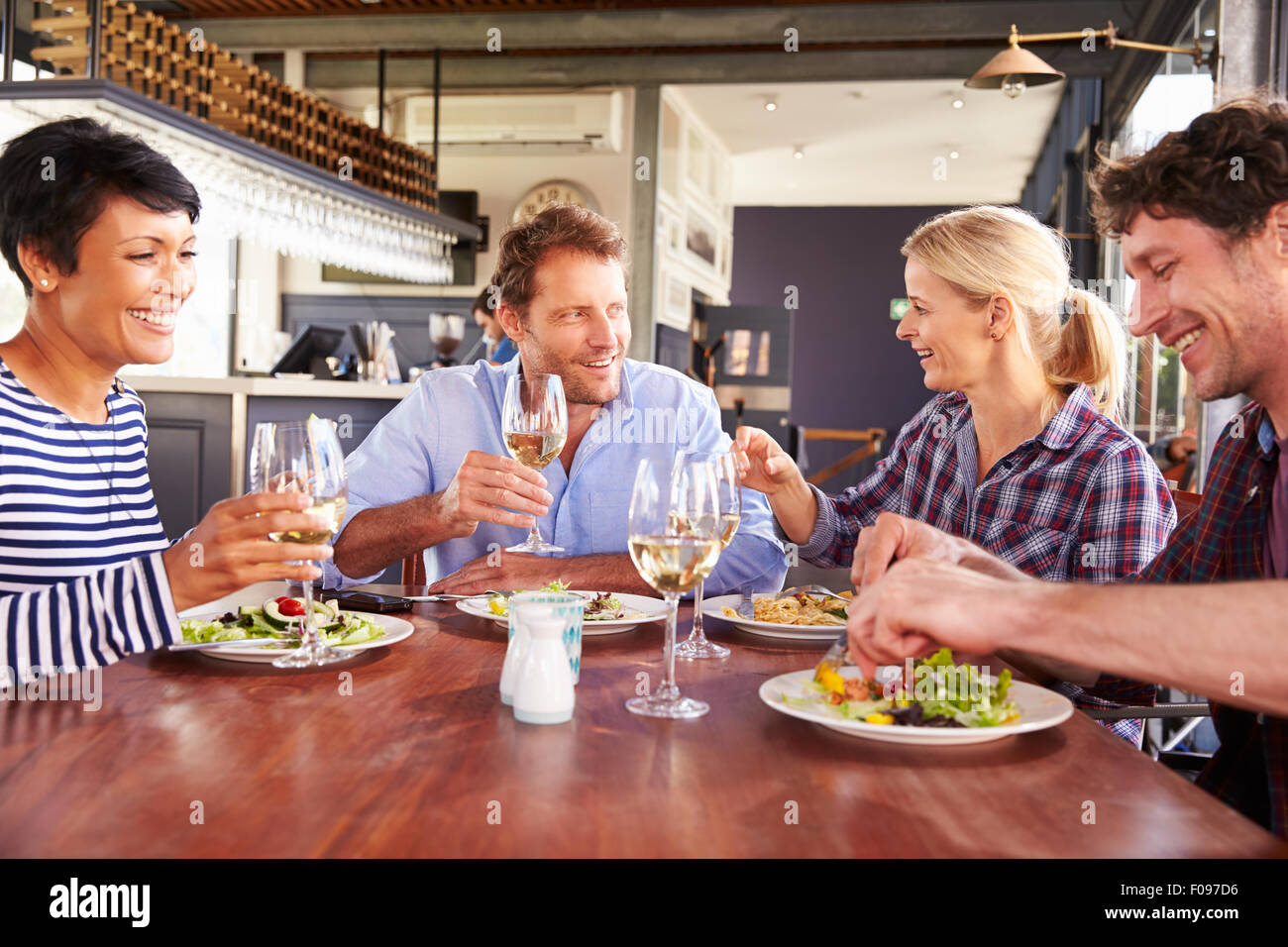 A group of friends having lunch in a restaurant Stock Photo - Alamy